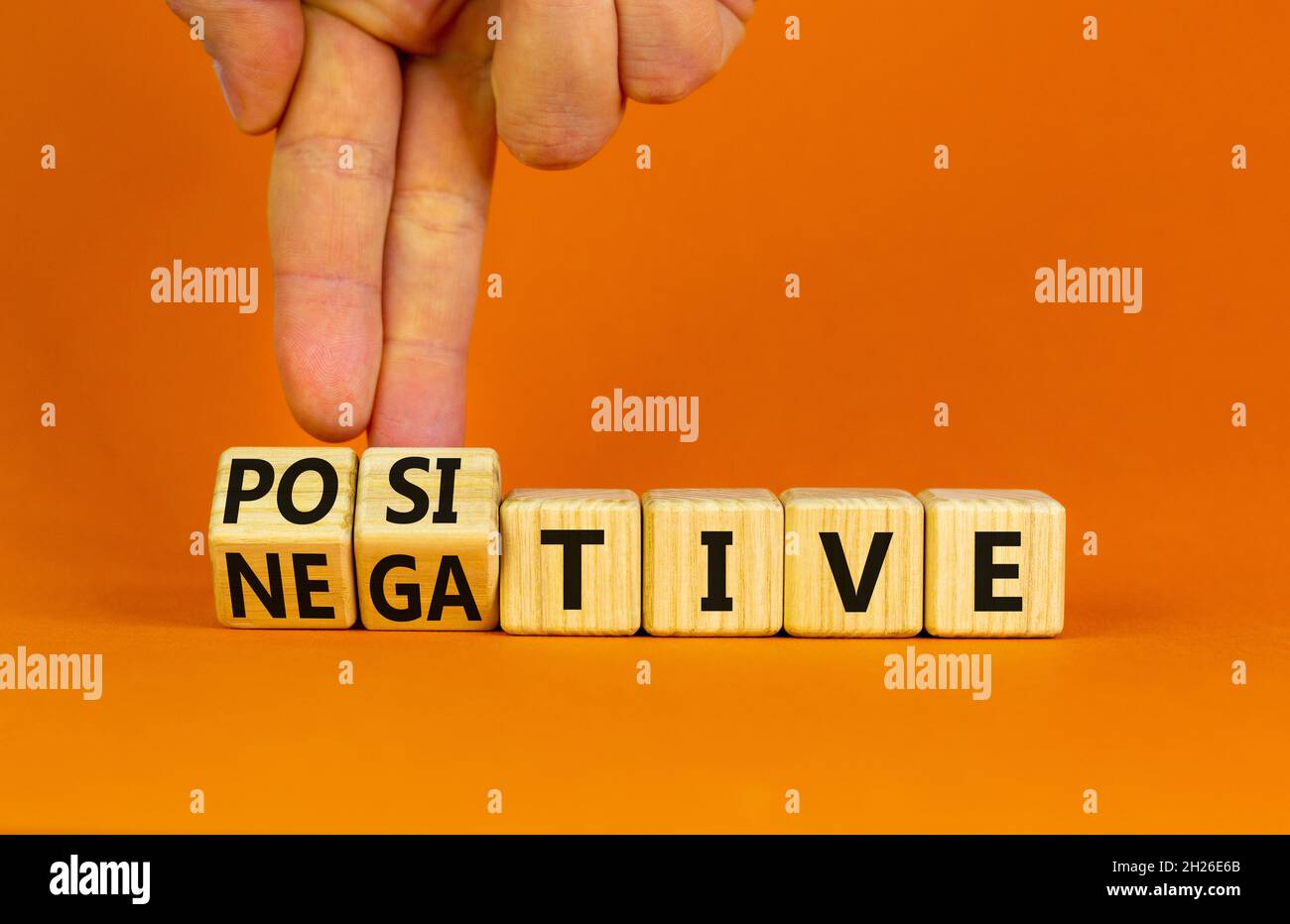 Positive or negative symbol. Businessman turns wooden cubes and changes ...