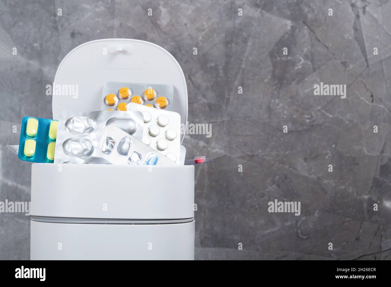 Expired pills collected in rubbish bin. Medicine recycle concept Stock ...