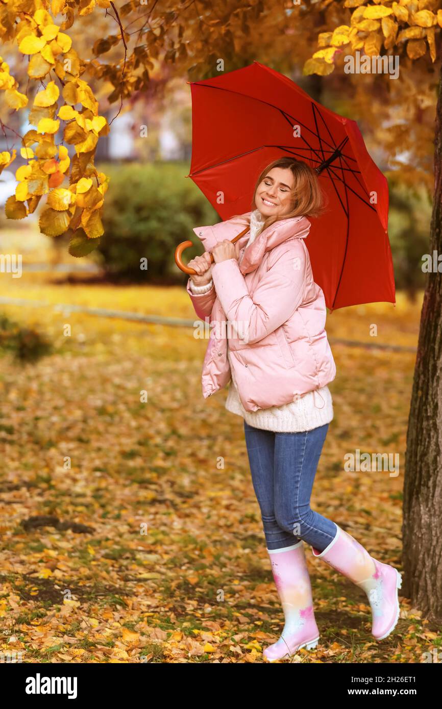 Woman with umbrella in autumn park on rainy day Stock Photo - Alamy