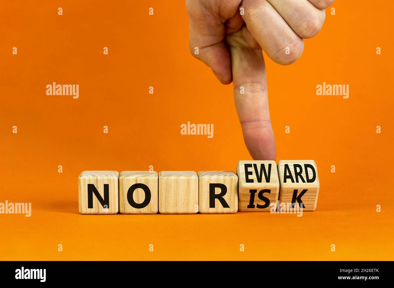 No risk and reward symbol. Businessman turns wooden cubes and changes ...