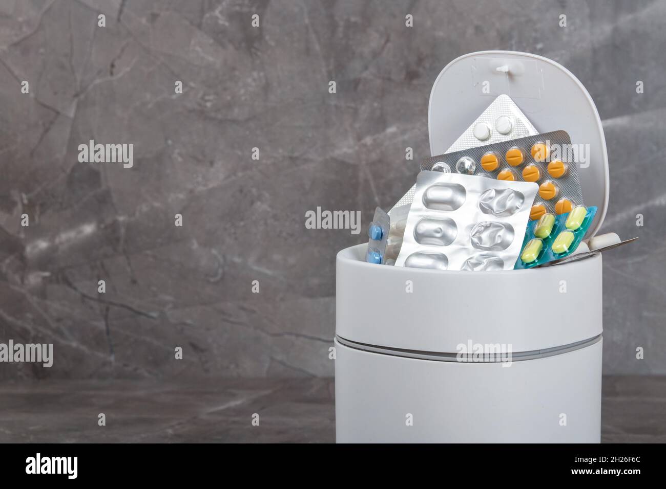 Expired pills collected in rubbish bin. Medicine recycle concept Stock ...