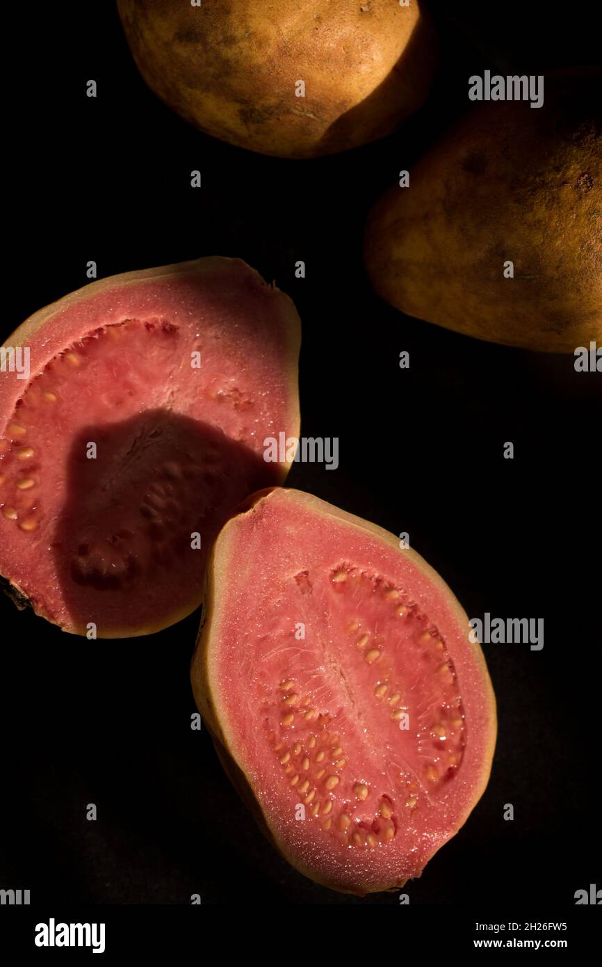 Vertical shot of guava sliced into two pieces Stock Photo - Alamy