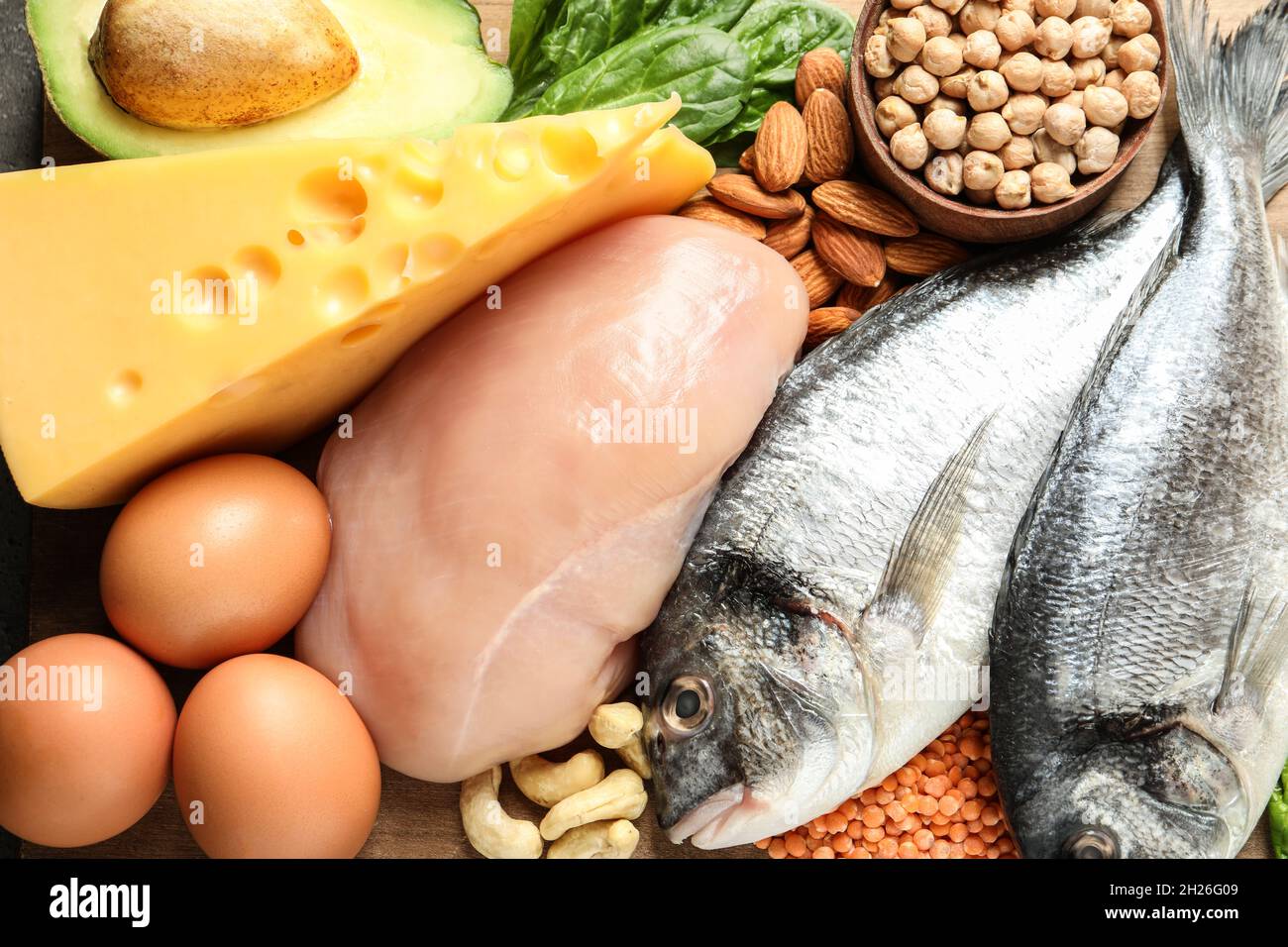 Set of natural food high in protein on wooden background, top view ...