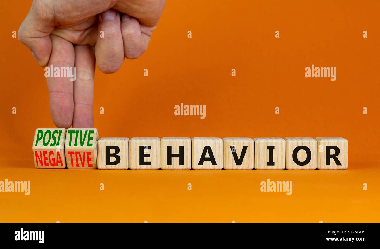Positive or negative behavior symbol. Businessman turns cubes, changes ...
