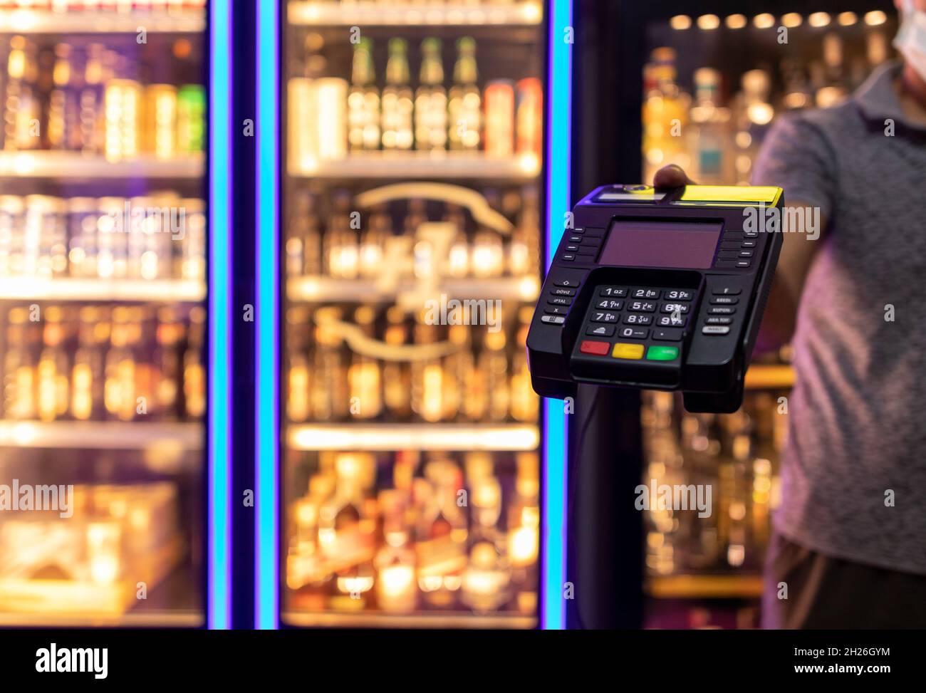 Man holding pos device in alcohol shop Stock Photo - Alamy