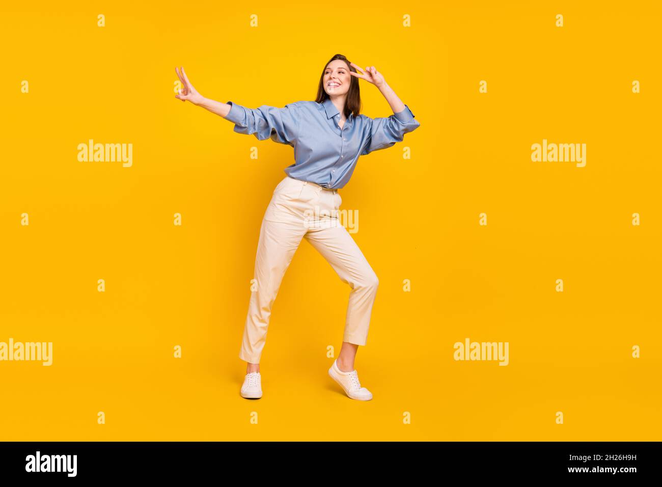 Photo of funny cute young lady dressed blue outfit showing v-signs ...