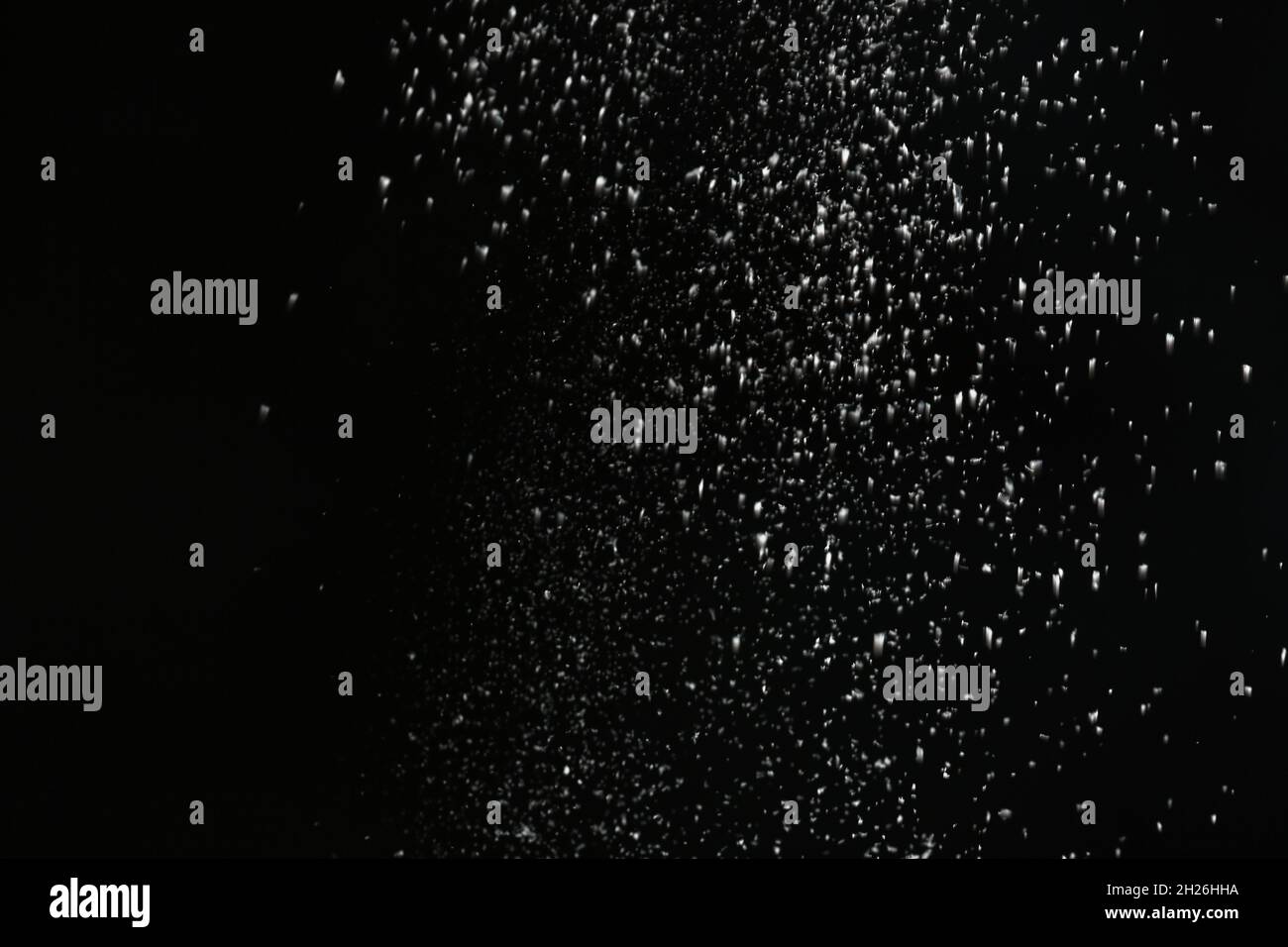 Snow flakes falling on black background. Winter weather Stock Photo - Alamy