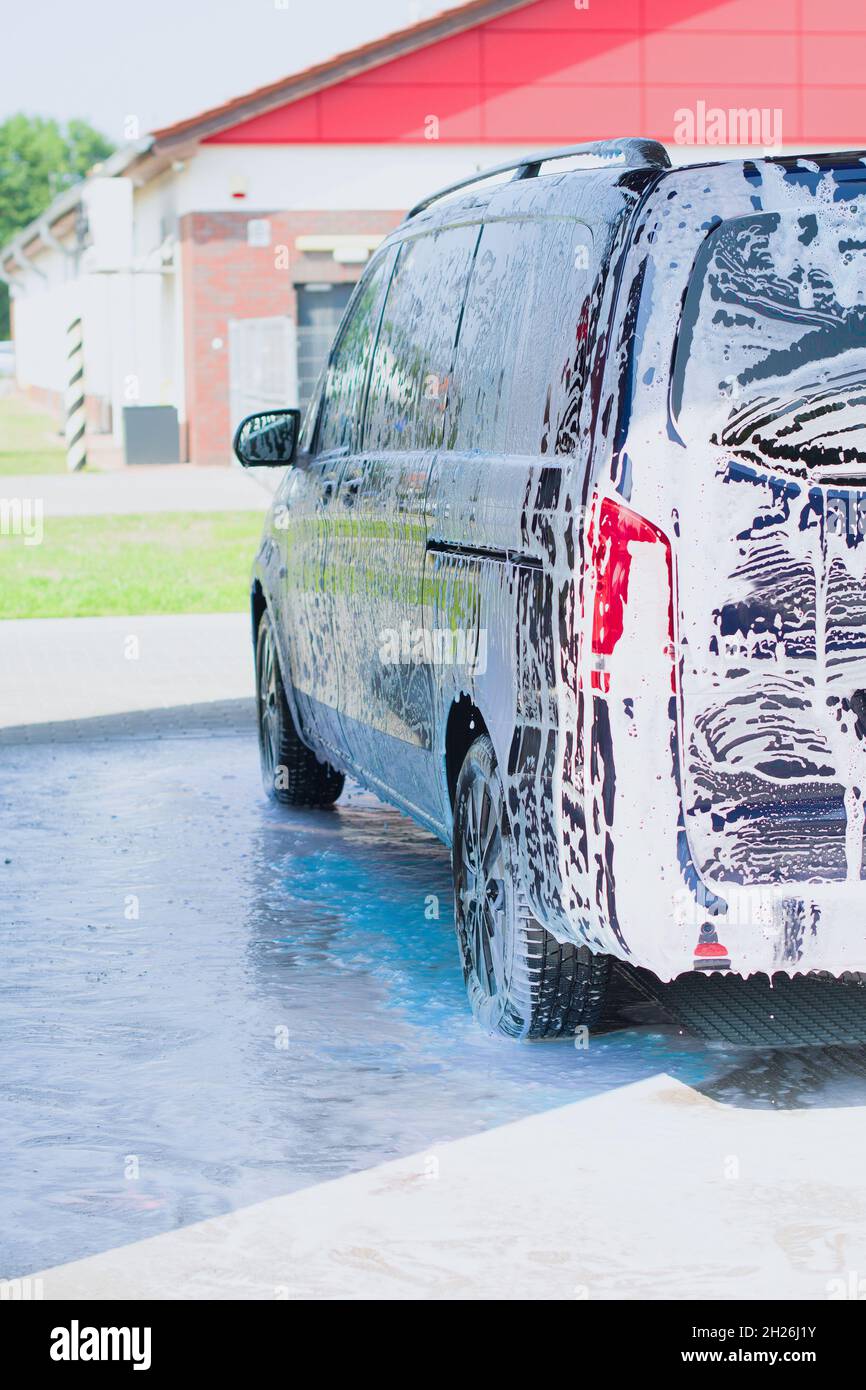 Man using water hose wash hi-res stock photography and images - Alamy