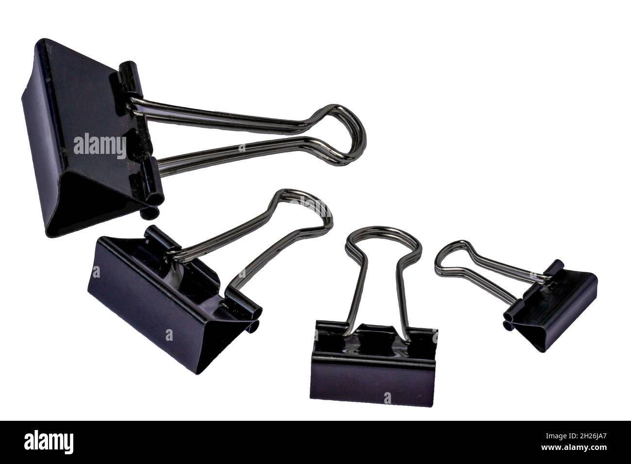 Four black metal paper clips, isolated with a white background, for ...