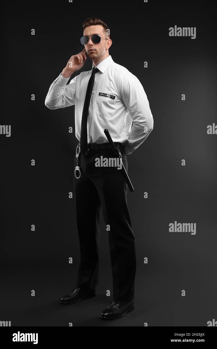 Male security guard in uniform on dark background Stock Photo - Alamy