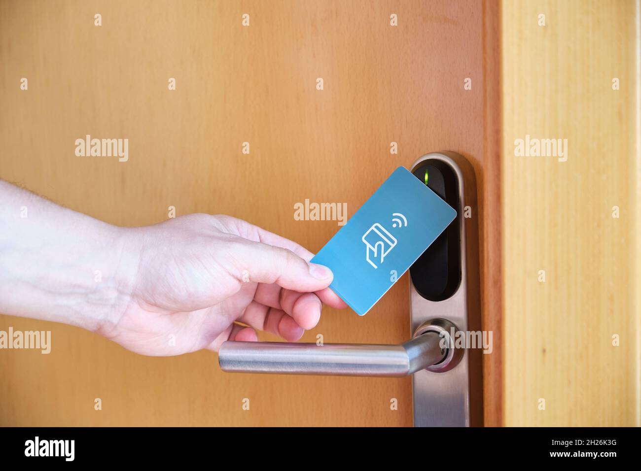 Male hand opening the hotel room electronic lock with a key card Stock ...