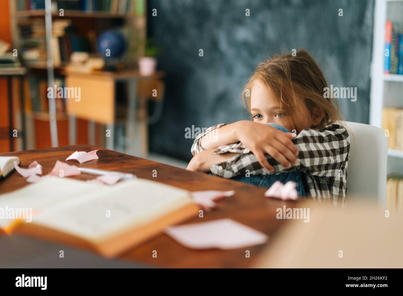 Sad girl sitting in classroom hi-res stock photography and images - Alamy