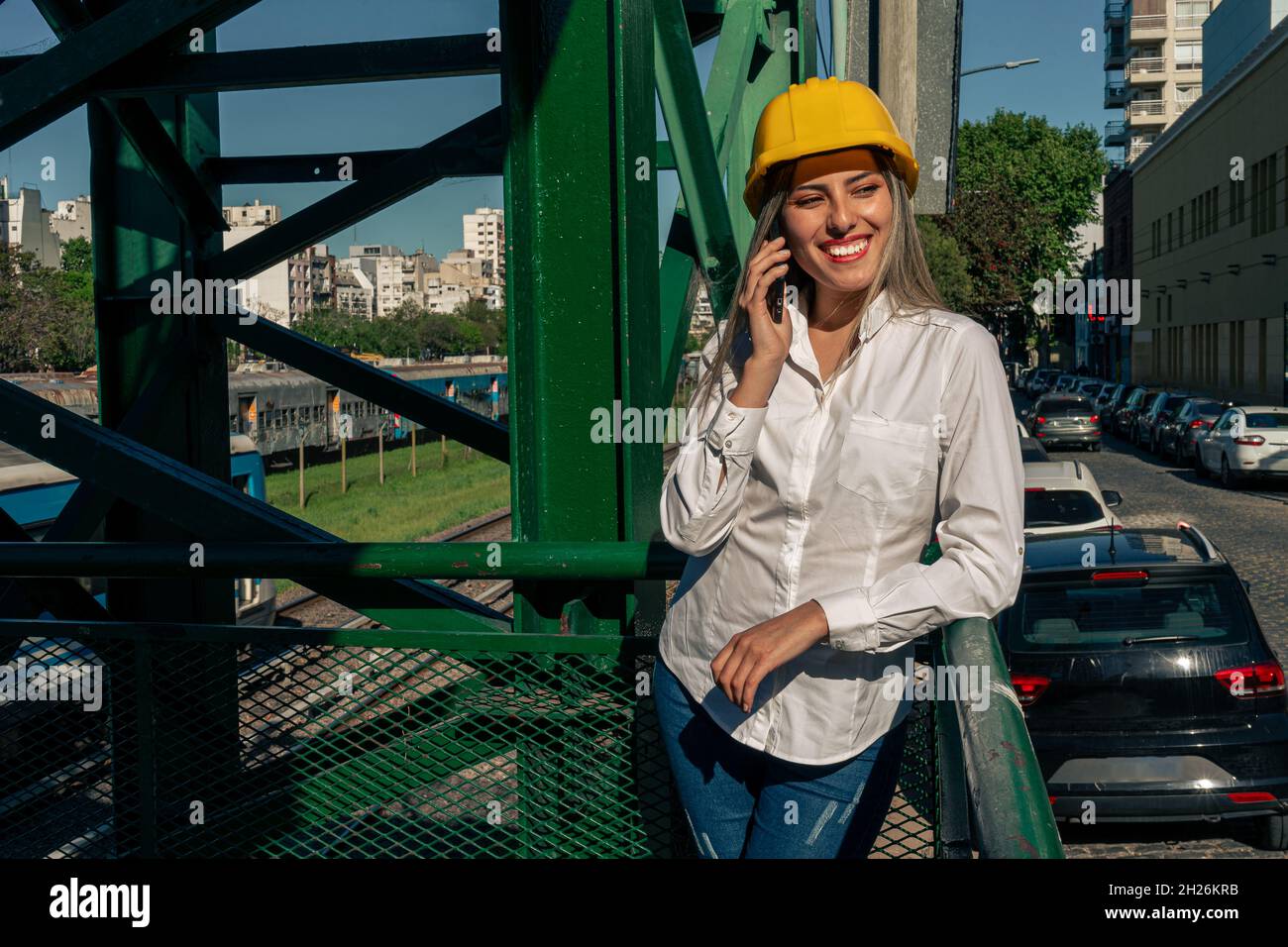 Beautiful young woman engineer or supervisor, wearing a safety helmet ...