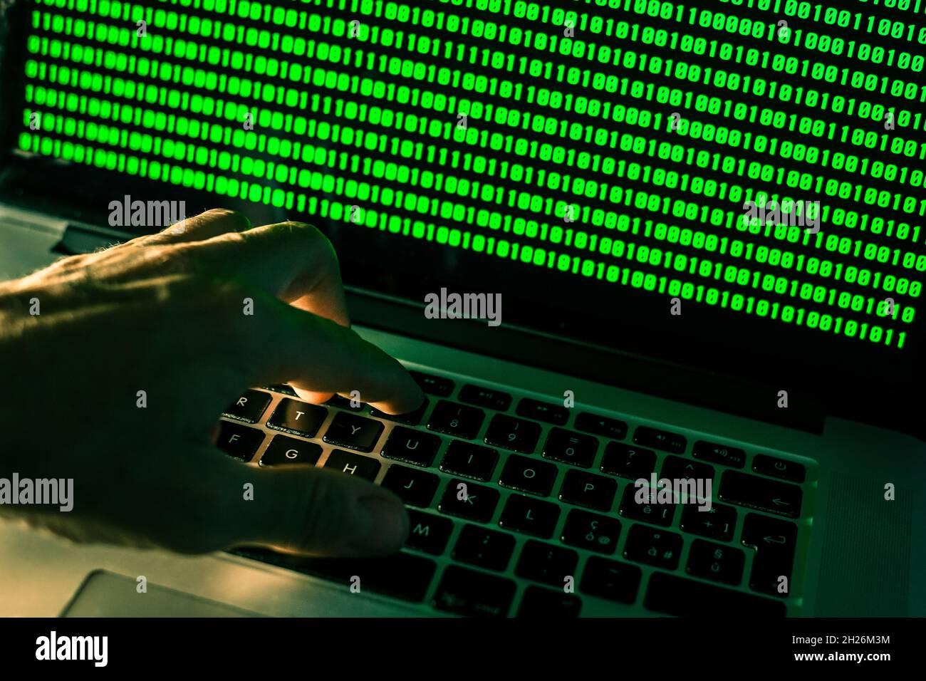 Hand Typing On Laptop Keyboard Green Numbers On Display Hacker