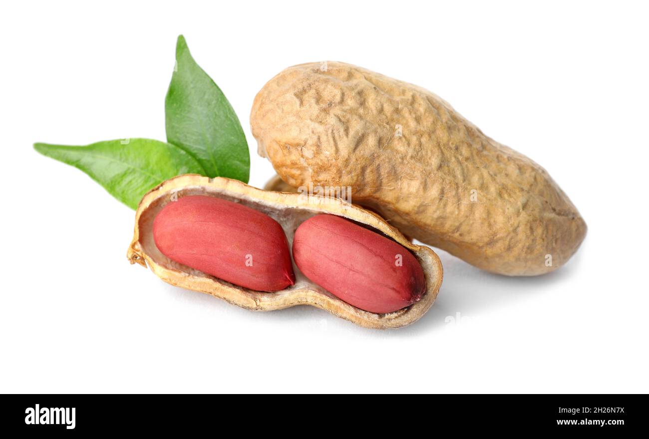 Raw peanuts and leaves on white background. Healthy snack Stock Photo ...