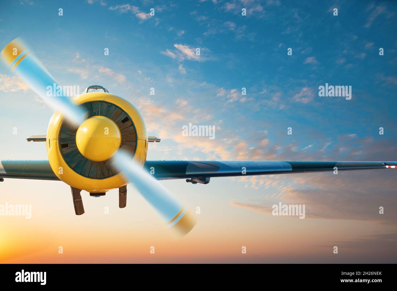 Small aircraft flying above in the blue sunset sky Stock Photo - Alamy
