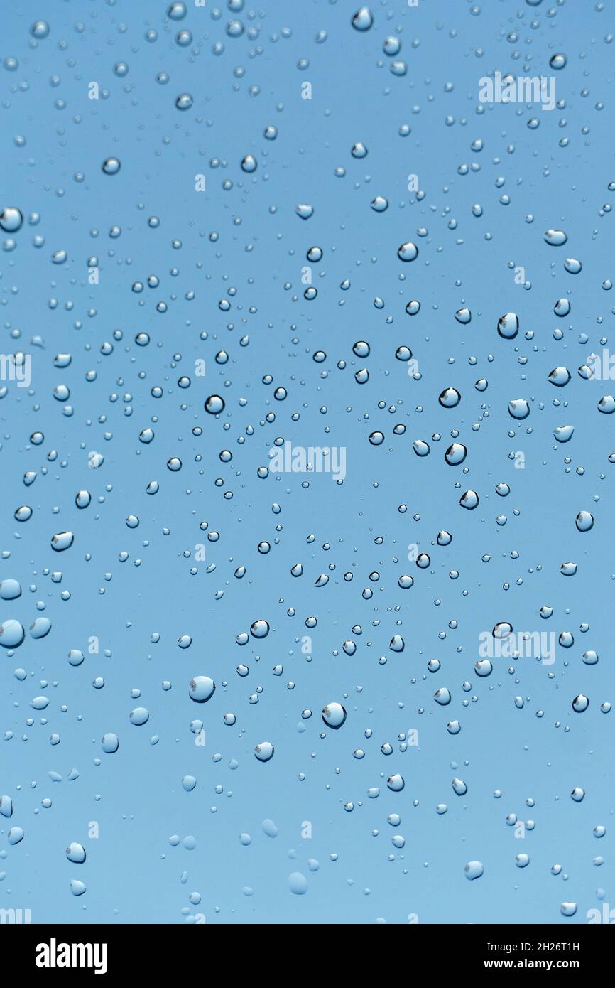 Raindrops on the window, moody blue sky, vertical shot Stock Photo - Alamy
