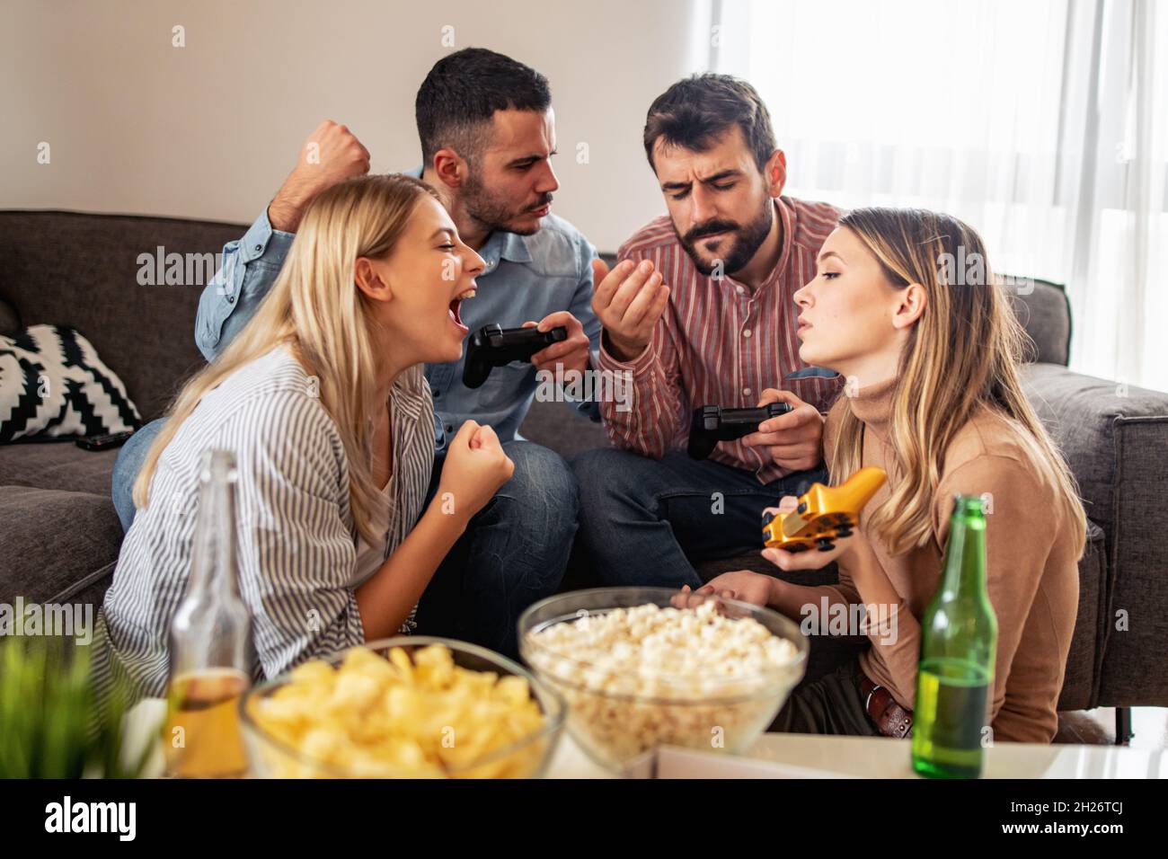 Happy friends playing video games at home.Happiness and gaming concept ...