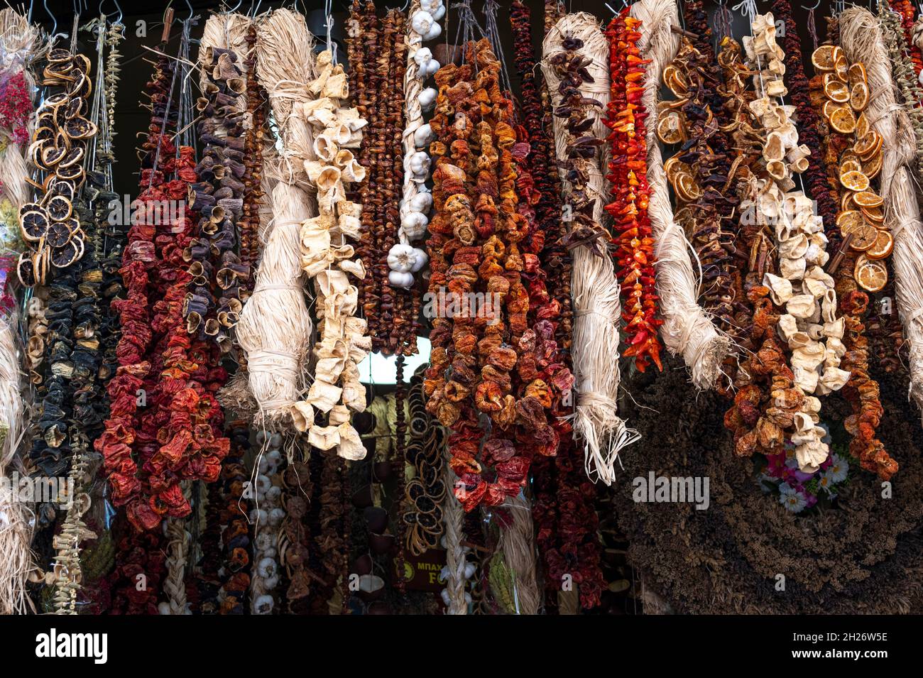 dried vegetables, spices hung up on strings for cooking being sold on ...