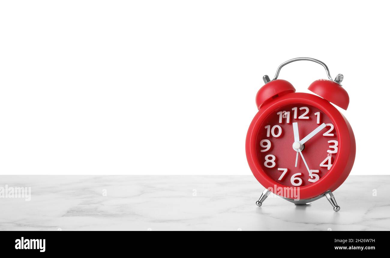 Alarm clock on table against white background. Time concept Stock Photo ...
