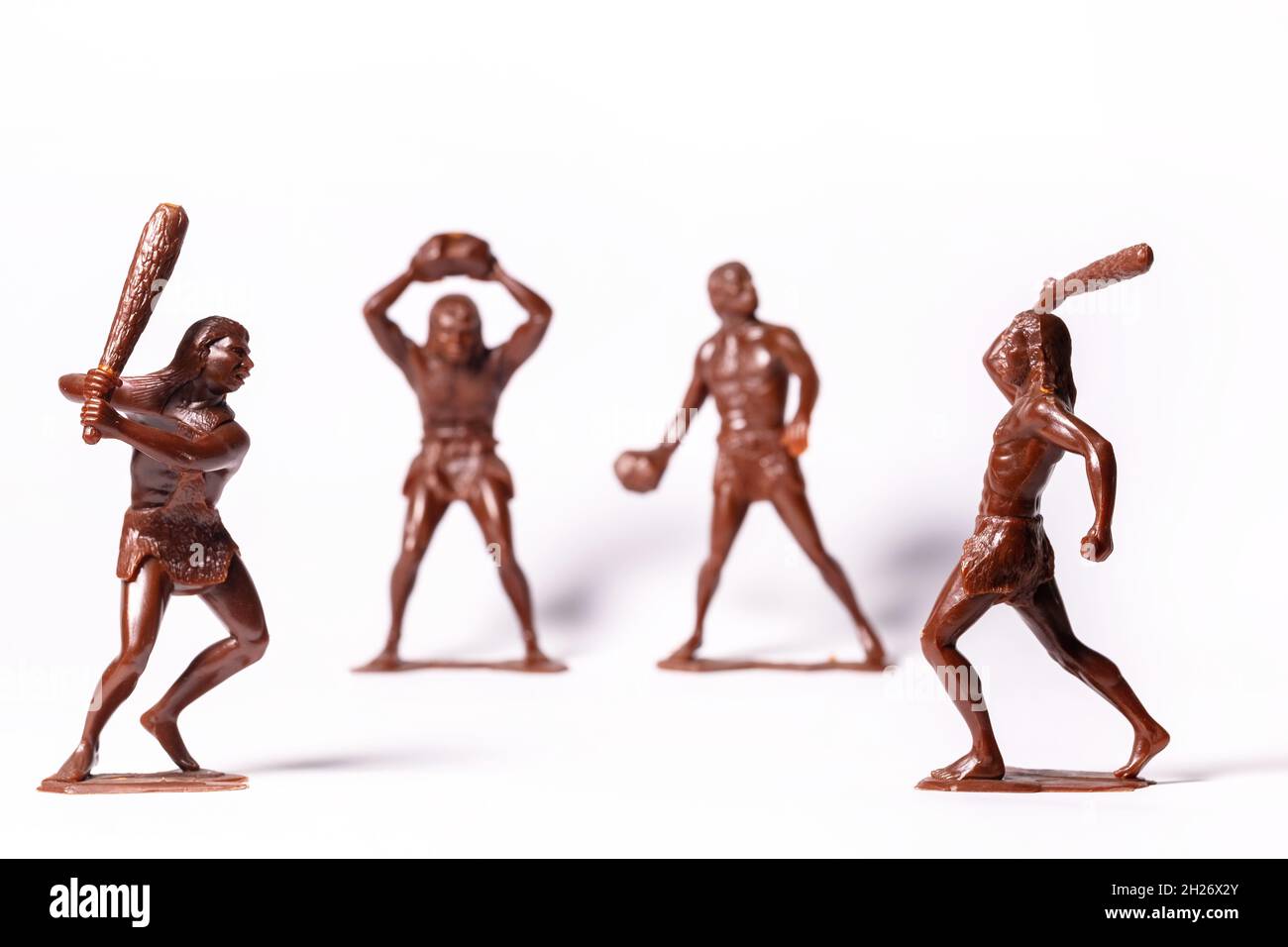 Large toy figures of primitive people on a white background Stock Photo ...