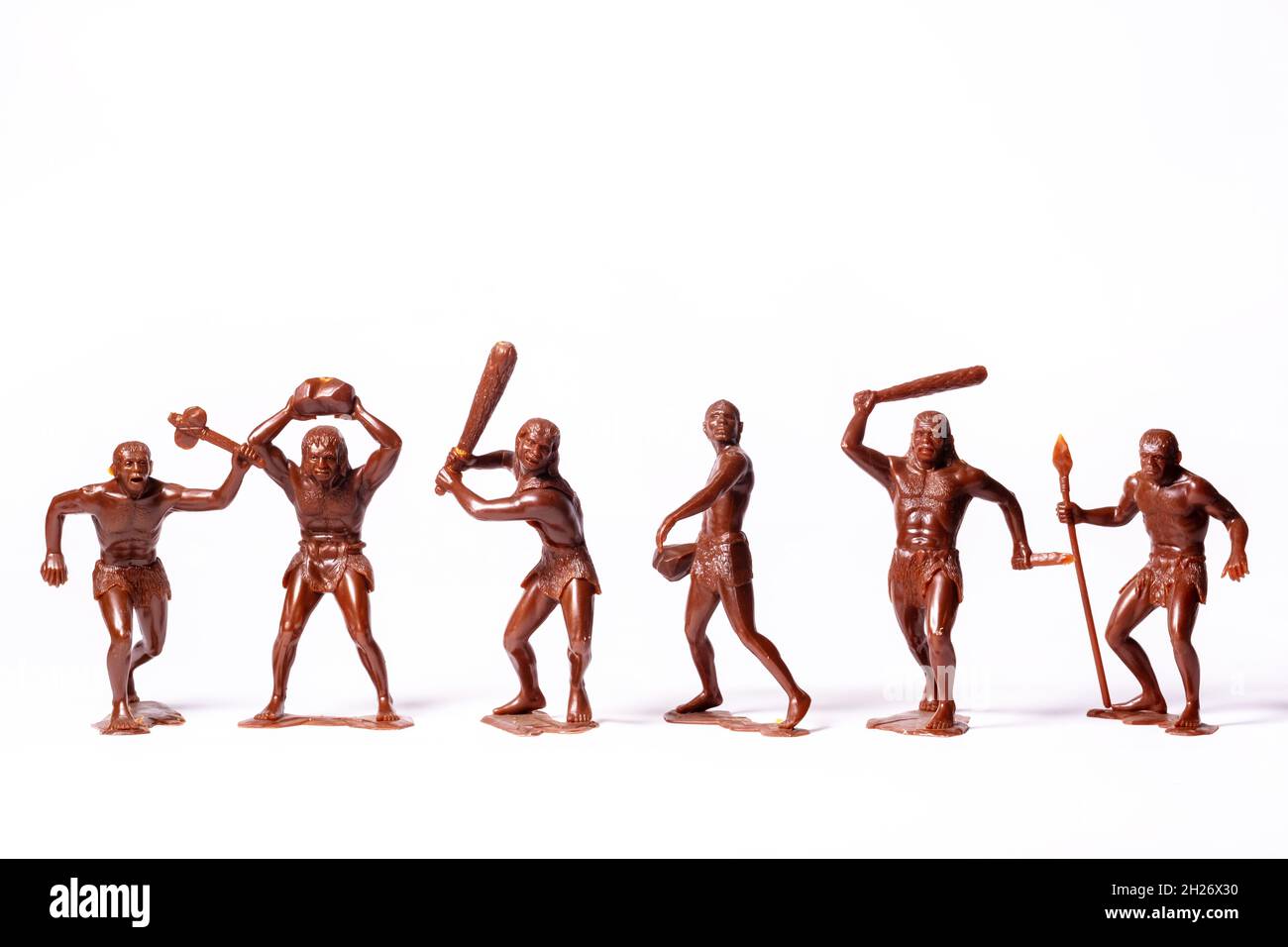 Large toy figures of primitive people on a white background Stock Photo ...