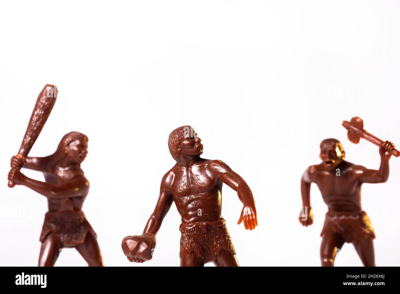 Large toy figures of primitive people on a white background Stock Photo ...