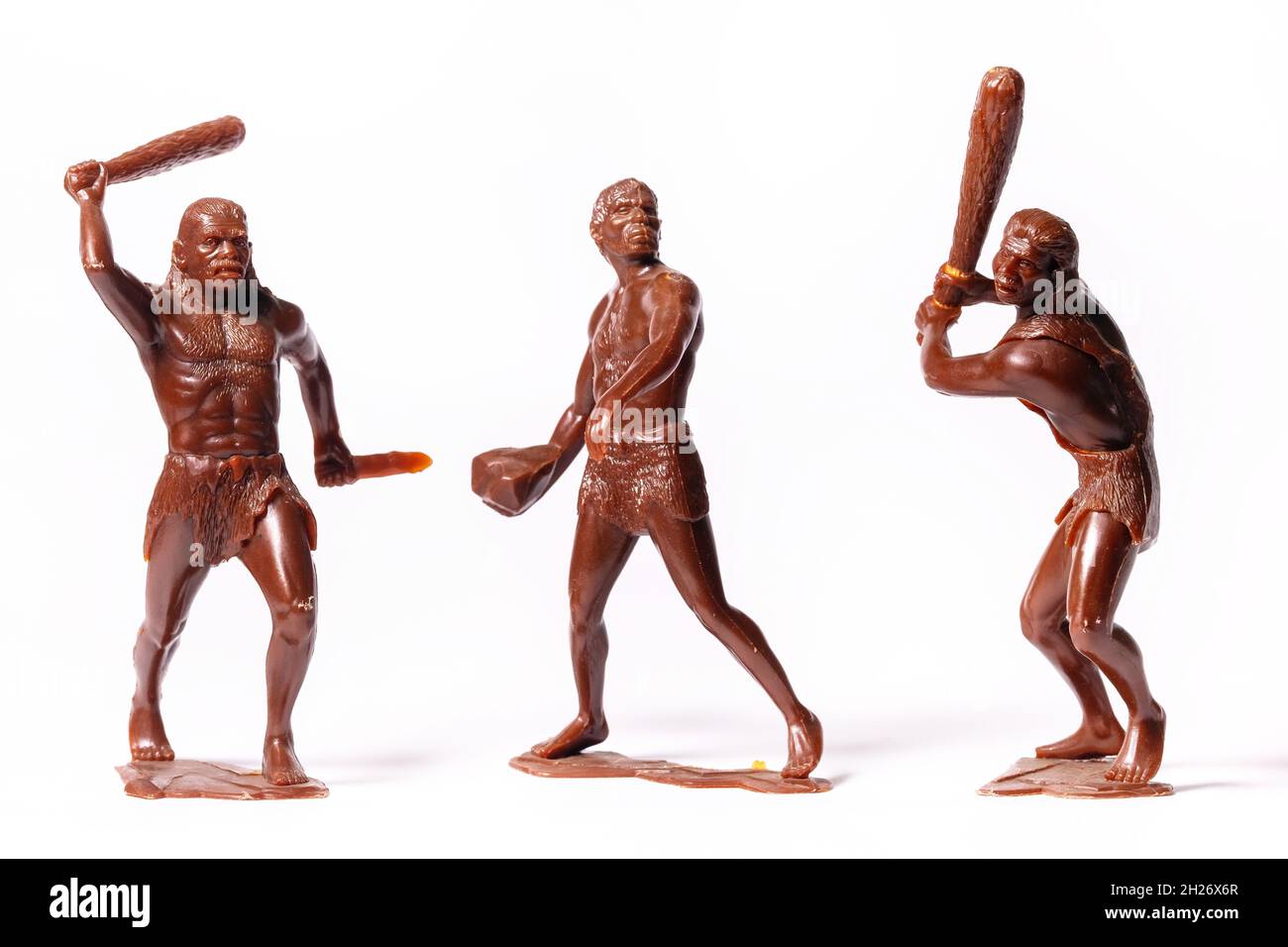Large toy figures of primitive people on a white background Stock Photo ...