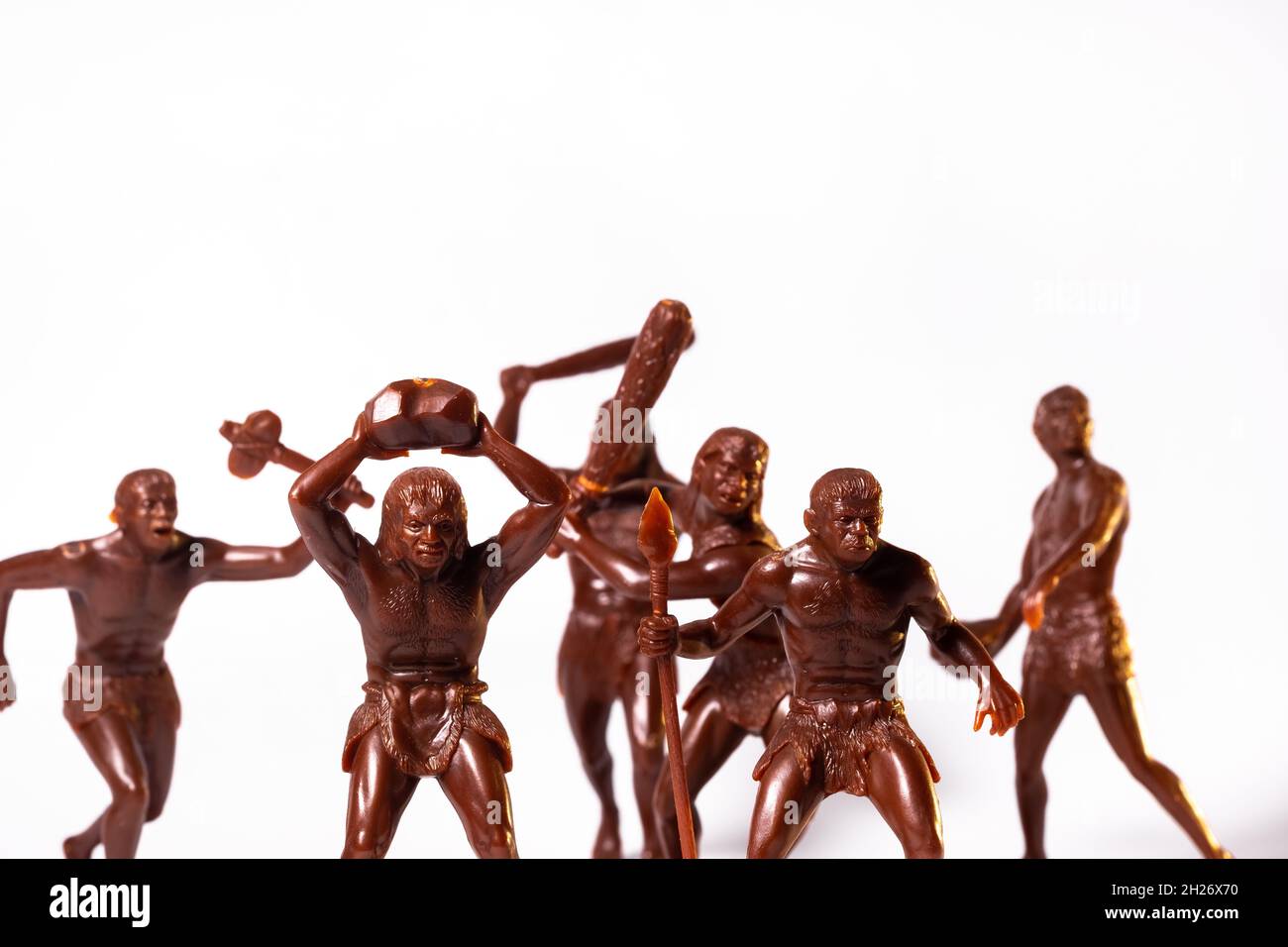 Large toy figures of primitive people on a white background Stock Photo ...