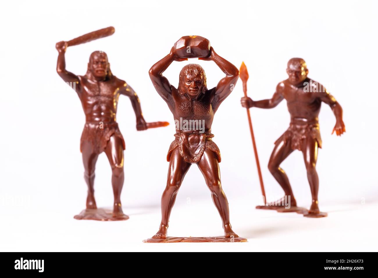 Large toy figures of primitive people on a white background Stock Photo ...
