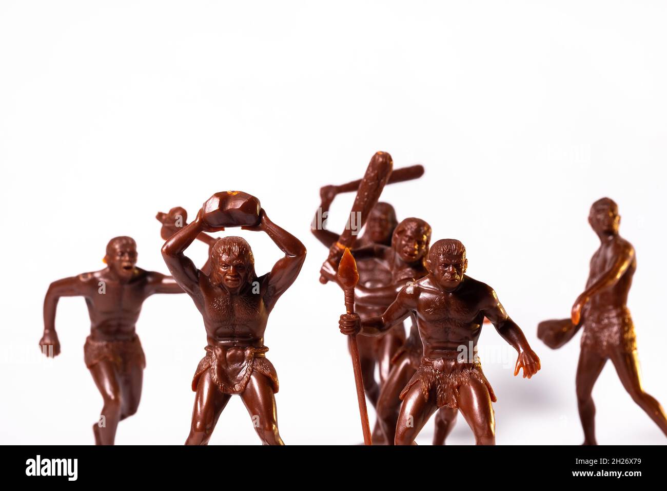 Large toy figures of primitive people on a white background Stock Photo ...