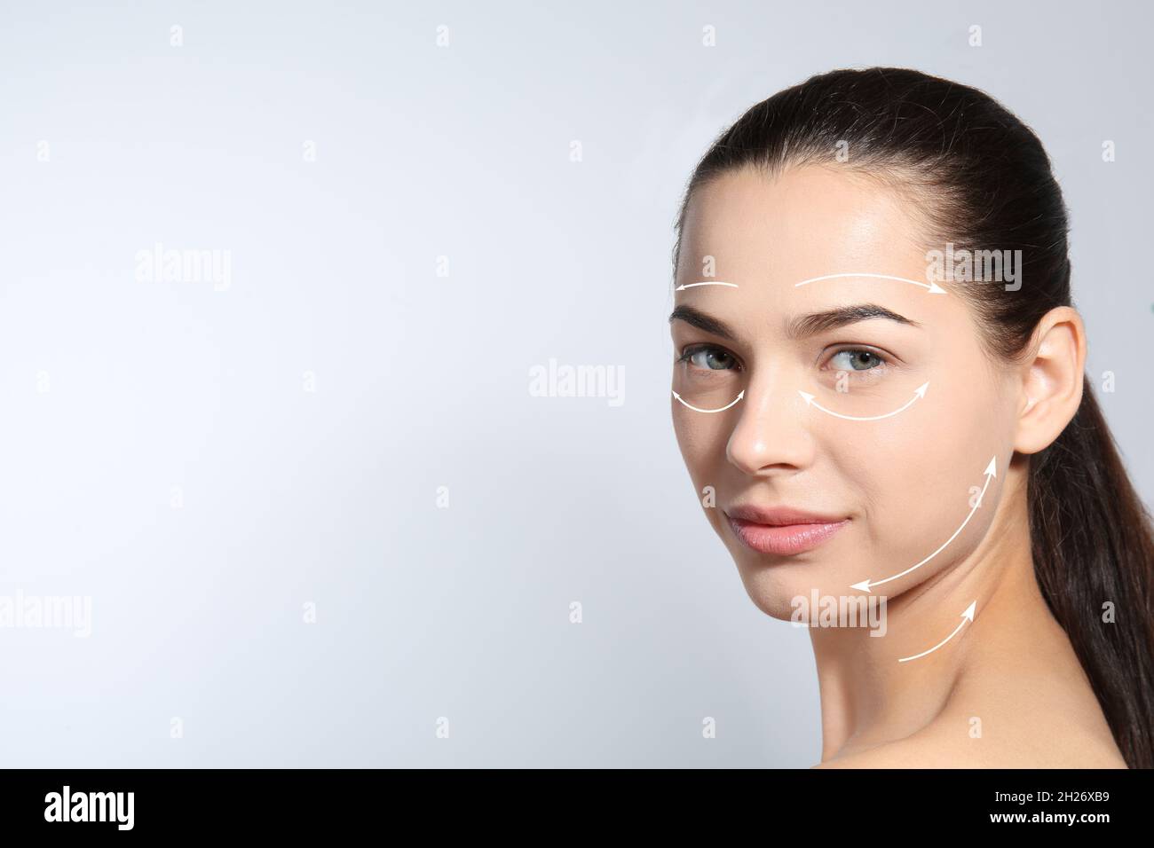 Young woman with face lifting marks and space for text on light ...