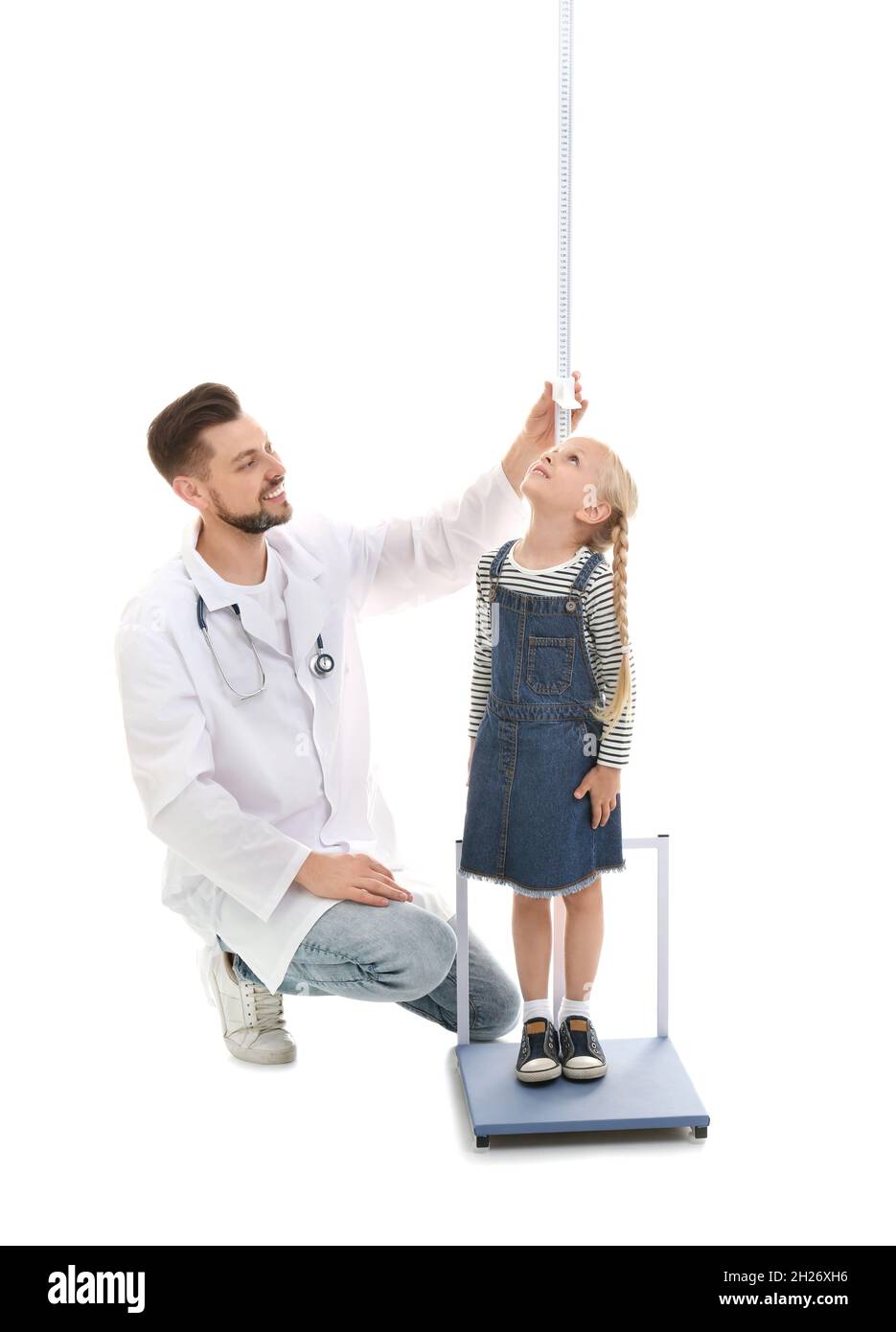 Doctor measuring girl height Cut Out Stock Images & Pictures - Alamy