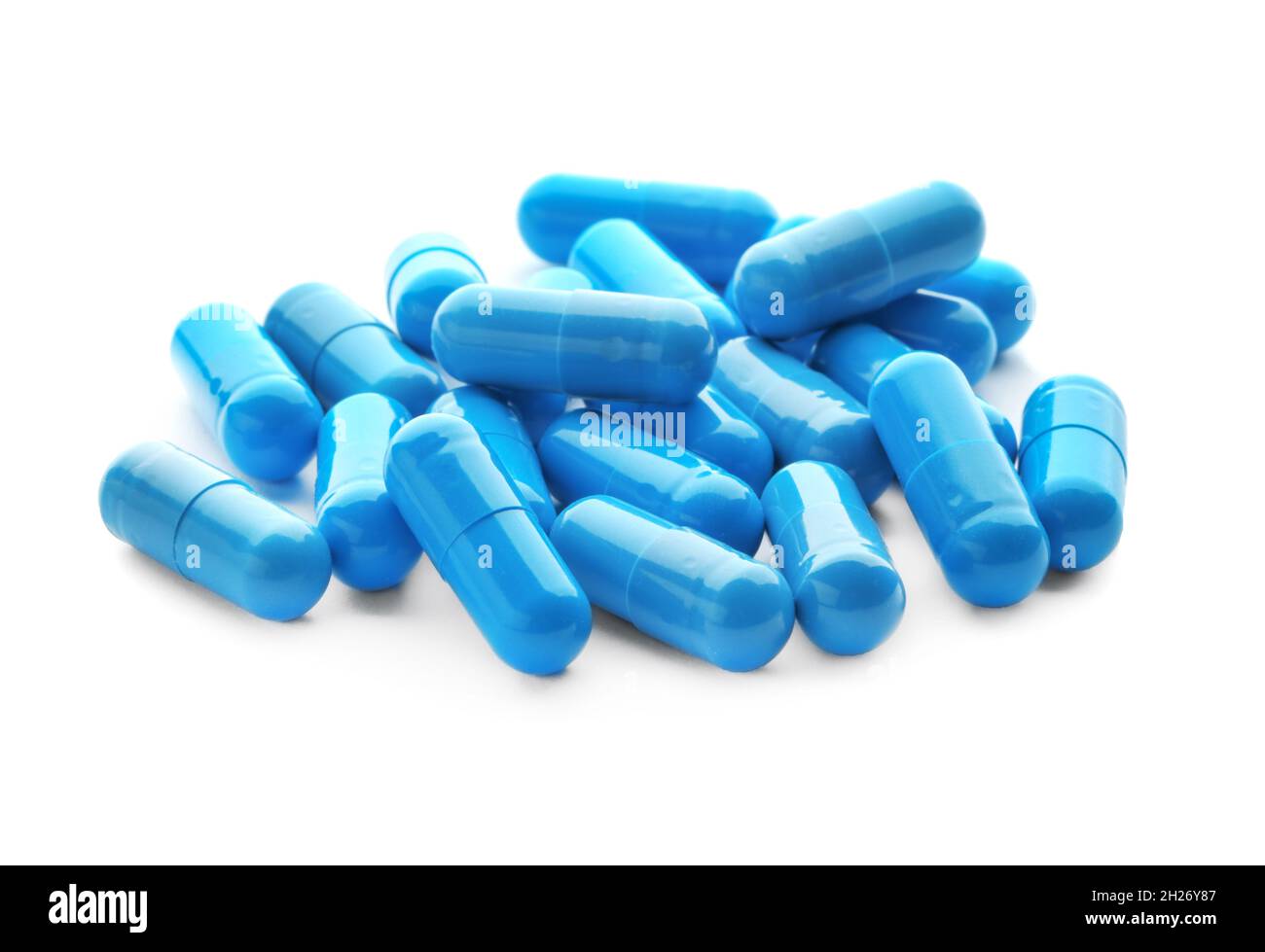 Blue capsules on white background Stock Photo - Alamy