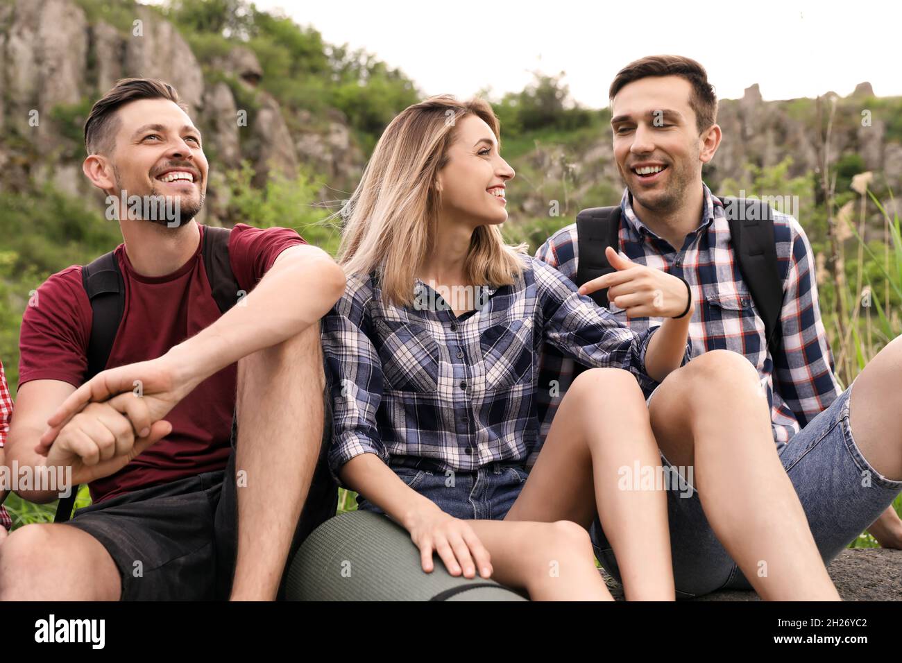 Young people with backpacks resting in wilderness. Camping season Stock ...