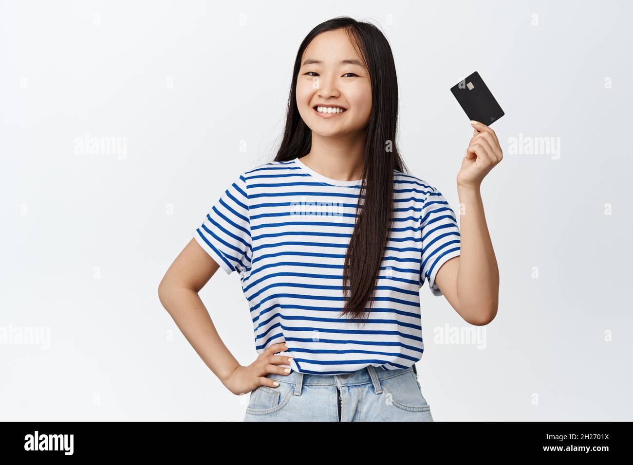 Happy asian woman raising hand and showing credit card, smiling ...