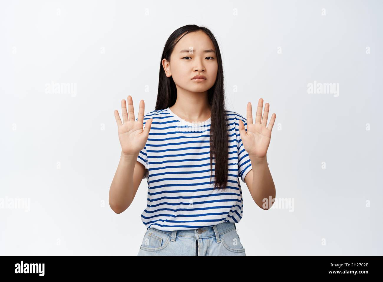 Image of serious asian woman tell to stop, say no, refusing something ...