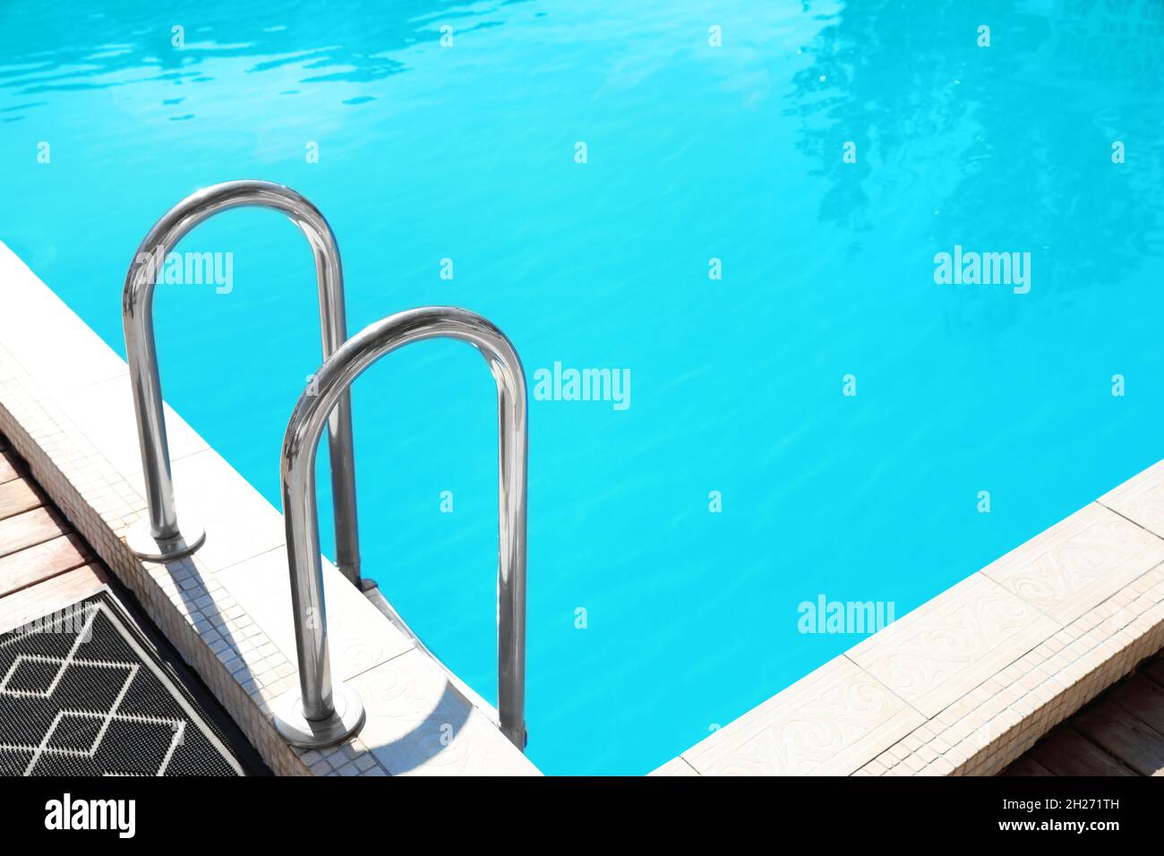 Modern swimming pool with step ladder outdoors Stock Photo - Alamy