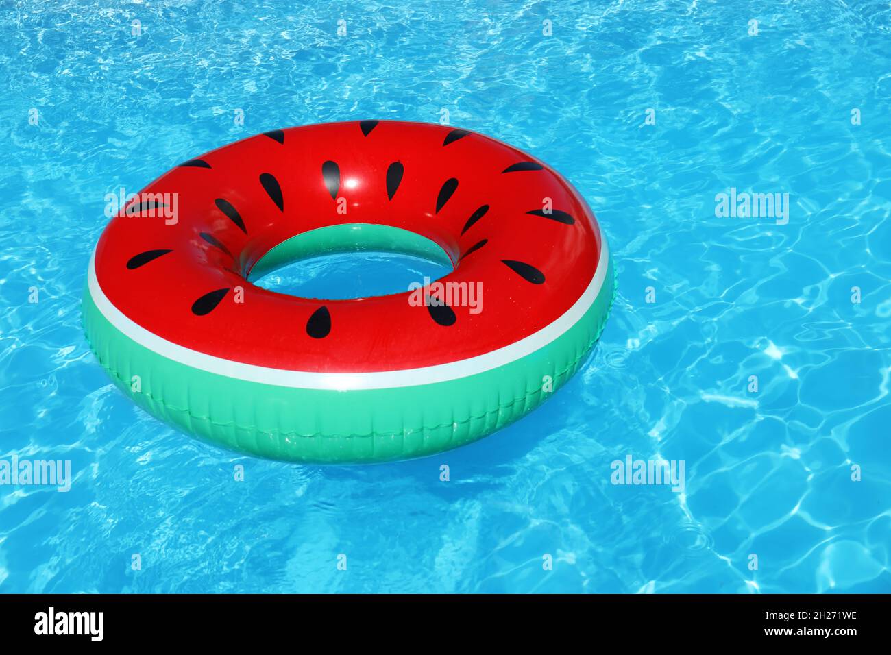 Inflatable ring floating in swimming pool on sunny day Stock Photo - Alamy