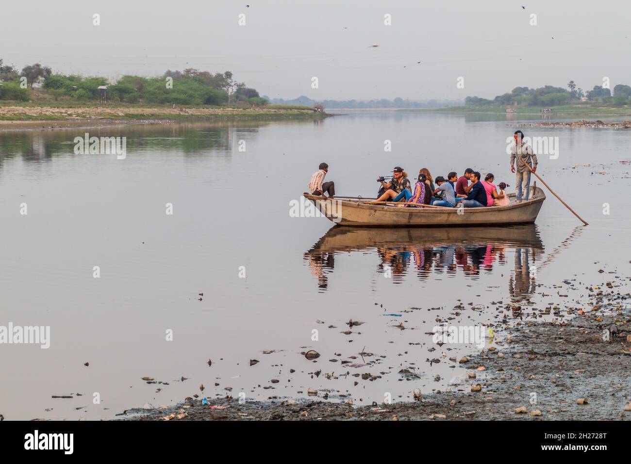 AGRA, INDIA - FEBRUARY 19, 2017: Tourists on a boat on Yamuna river ...
