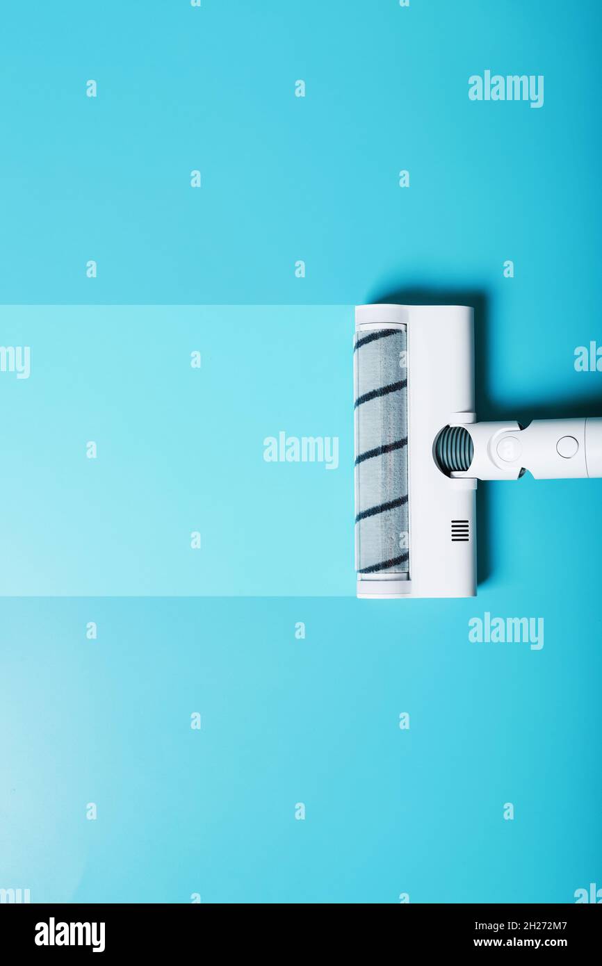 A vacuum cleaner nozzle with a clean stripe on a blue background. Free ...