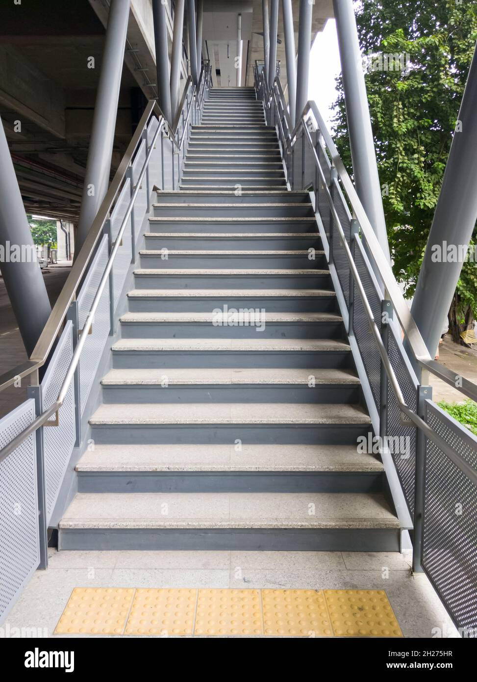 The empty modern staircase with the metal railing for entrance to the ...