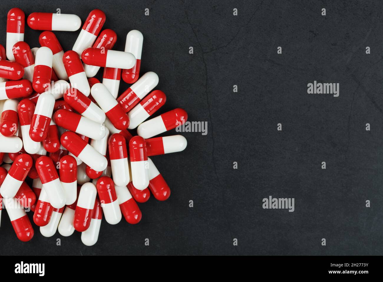 Medical red and white capsules isolated on a black background. Capsules ...