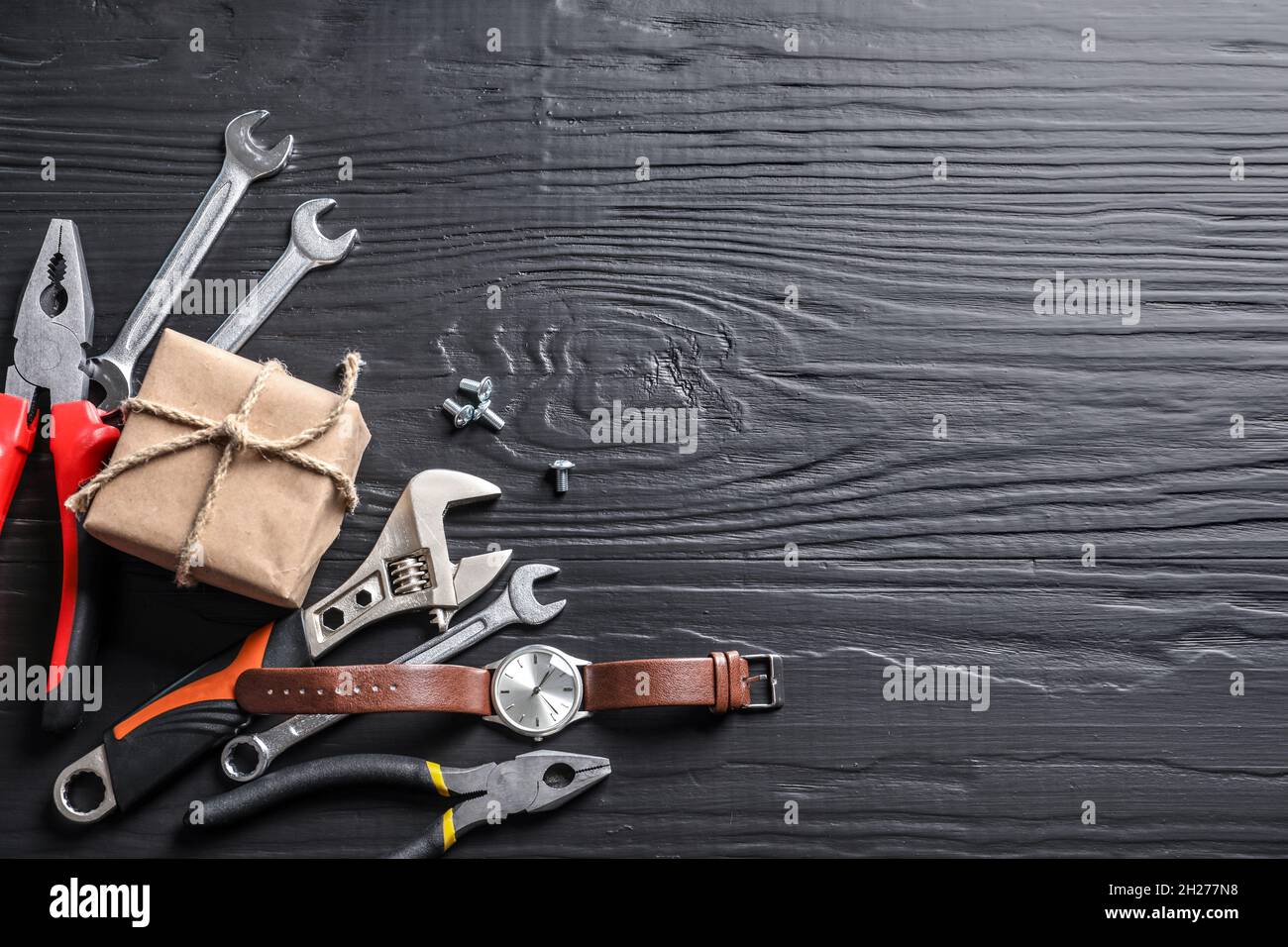 Flat lay composition with gift box, watch and instruments on wooden ...