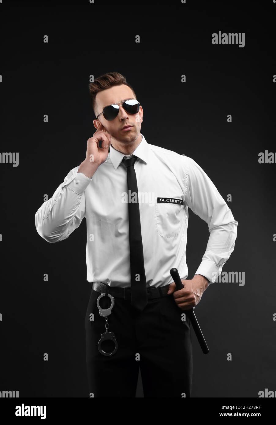 Male security guard in uniform on dark background Stock Photo - Alamy