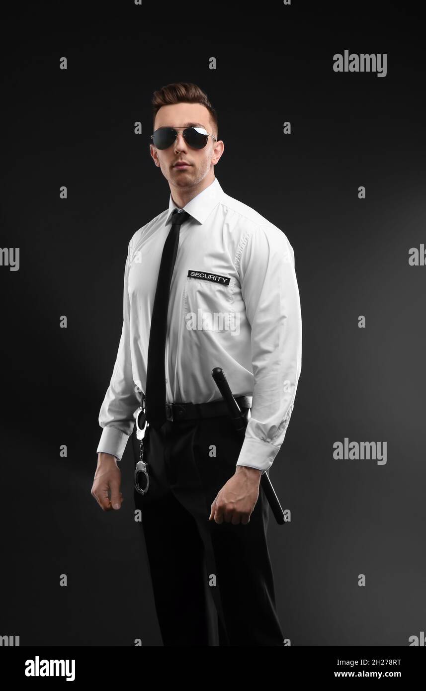 Male security guard in uniform on dark background Stock Photo - Alamy