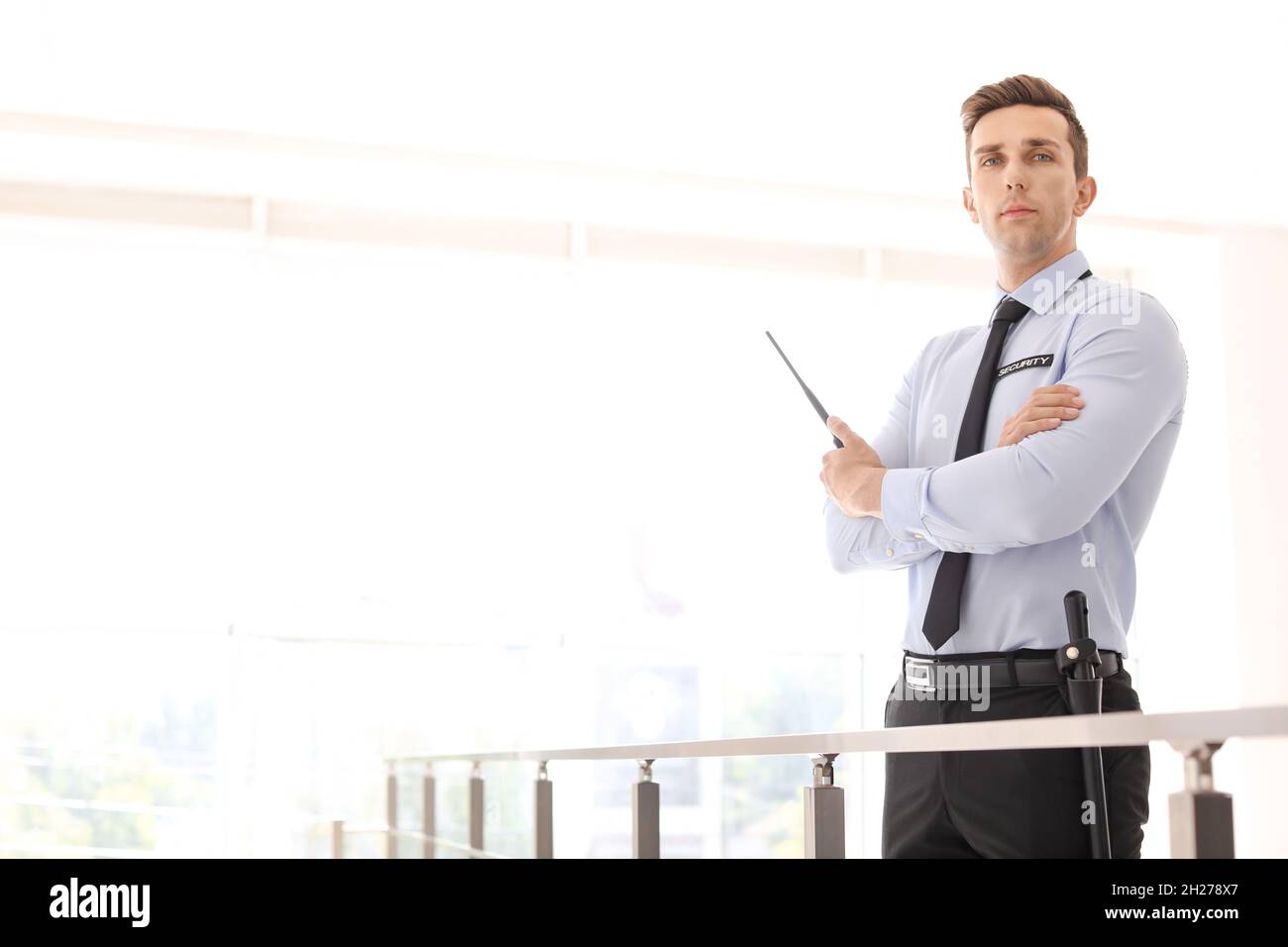 Male security guard with portable radio transmitter indoors Stock Photo ...