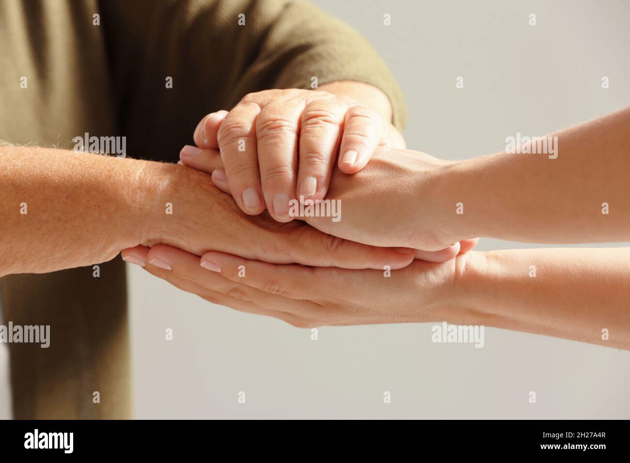 Helping hands on gray background, closeup. Elderly care concept Stock ...
