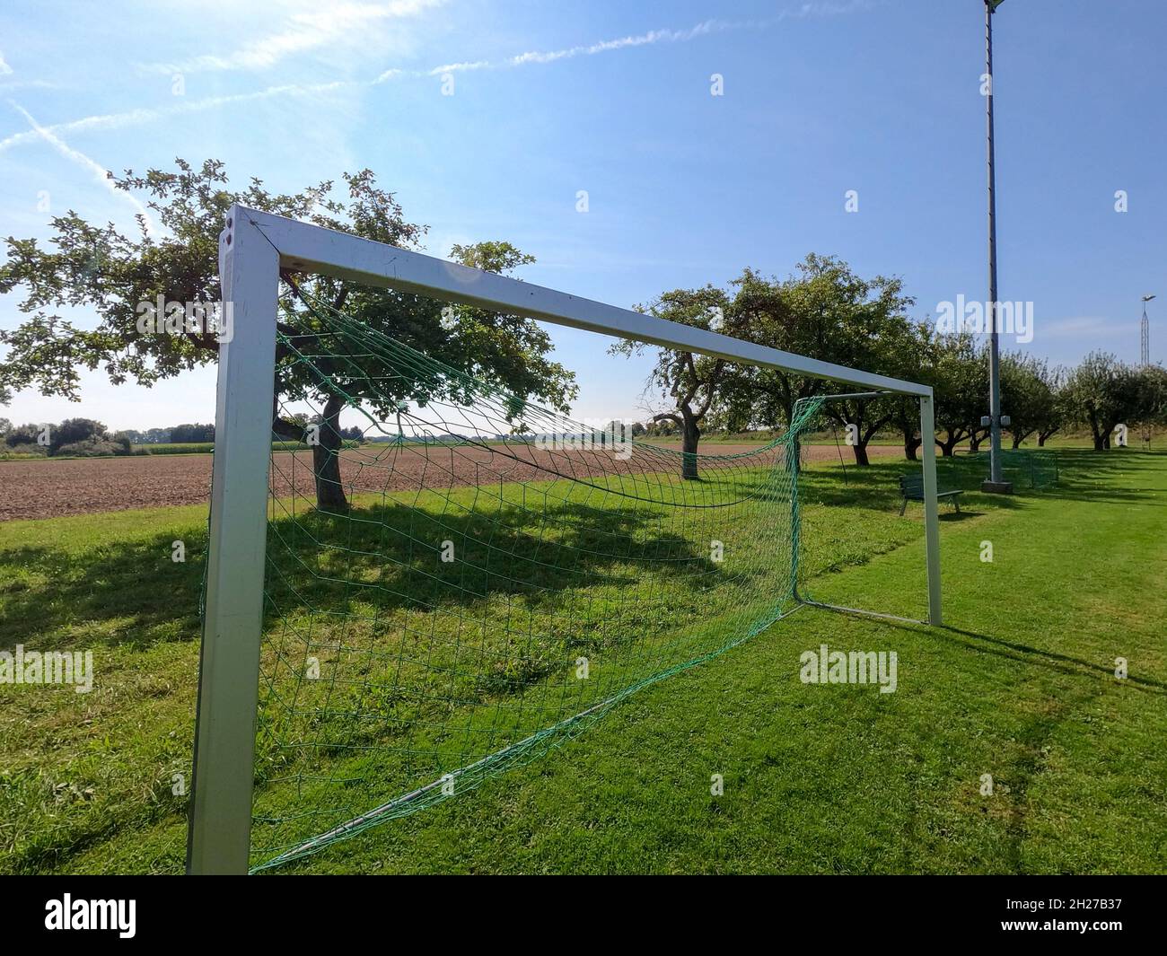 Landscape of soccer goal on greenfield during daytime Stock Photo - Alamy