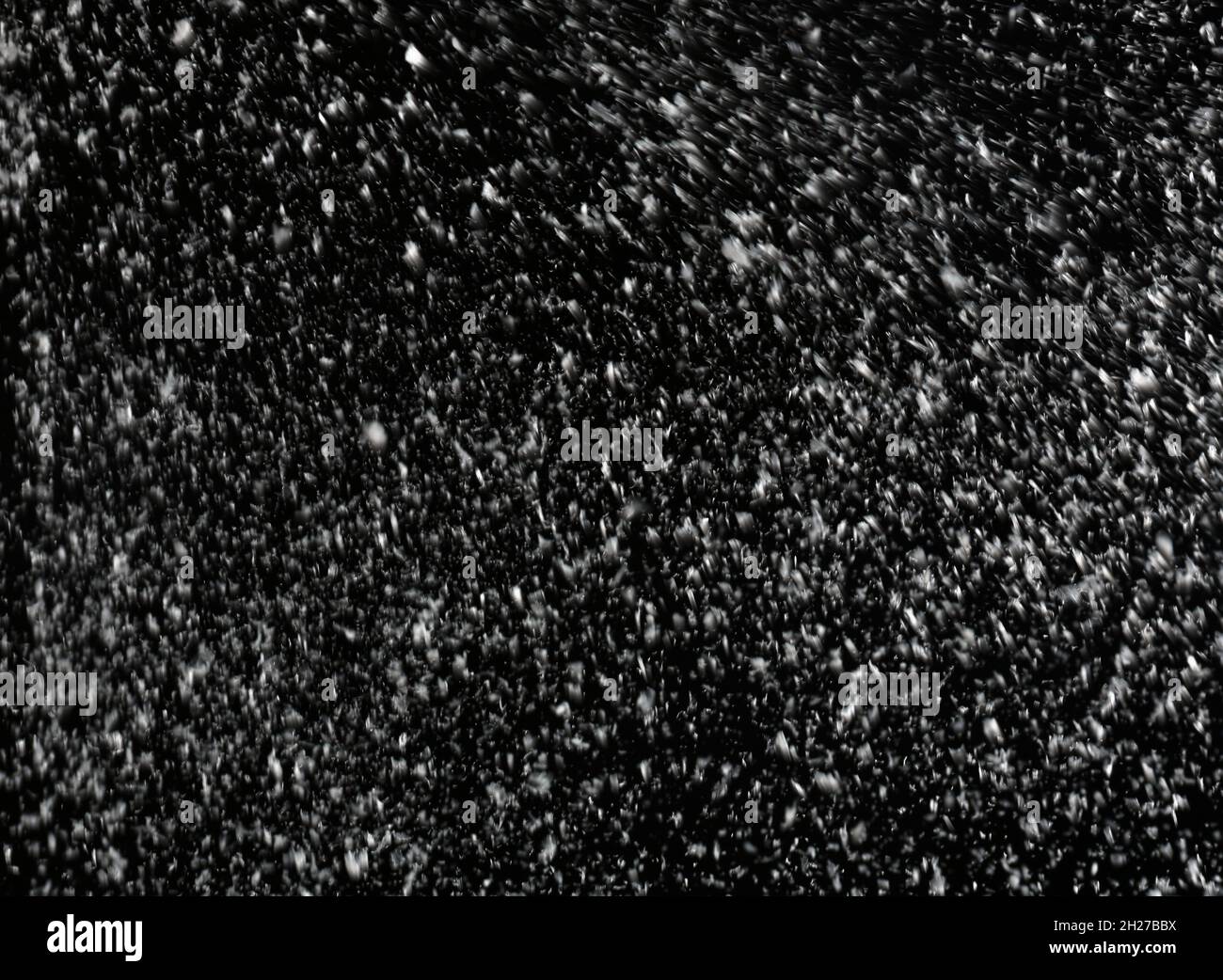 Snow flakes falling on black background. Winter weather Stock Photo - Alamy
